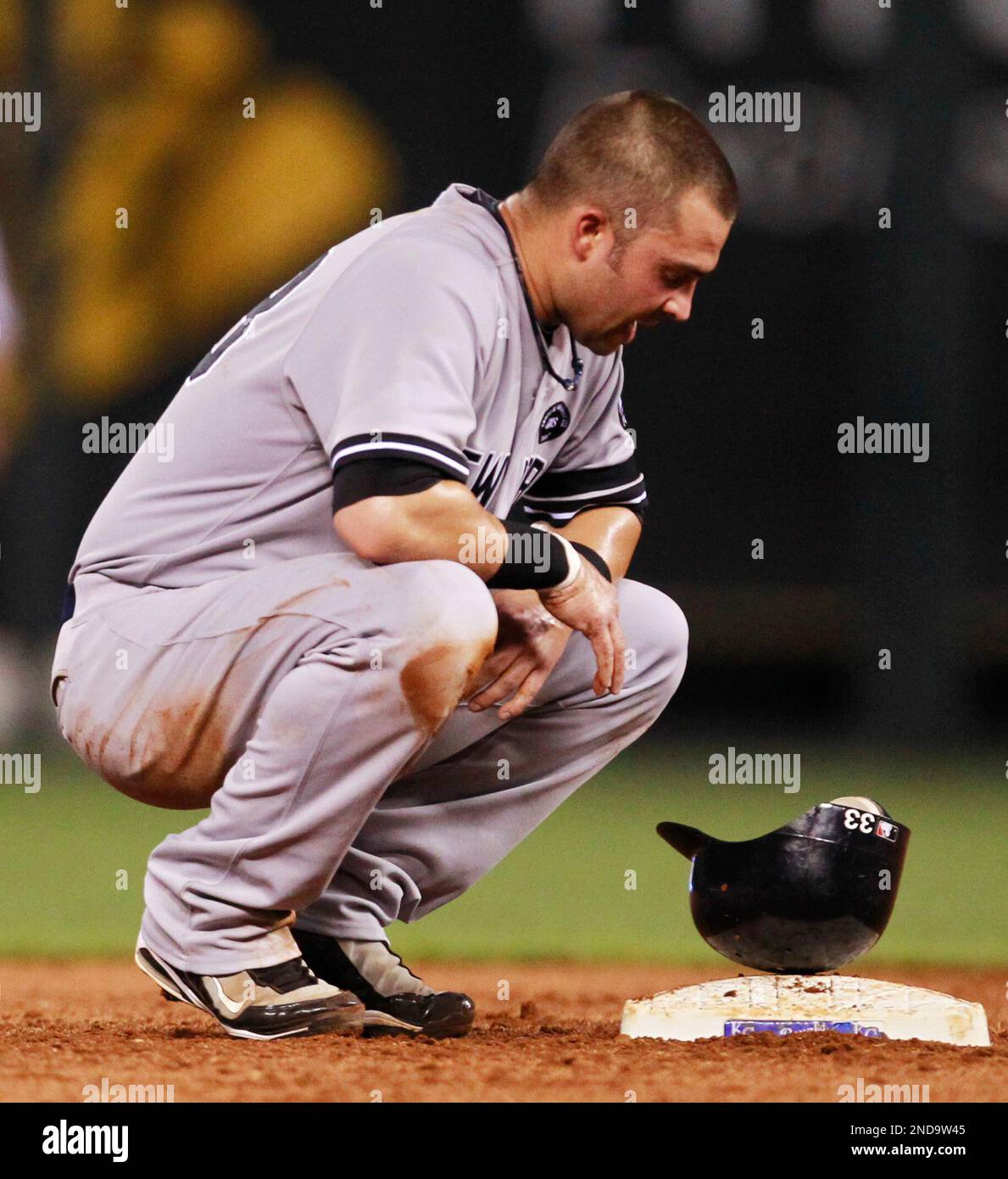 New York Yankees' Nick Swisher waits at second base during a meeting on ...