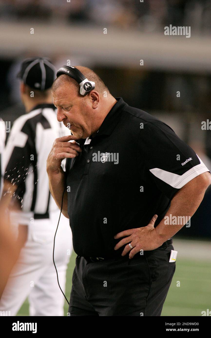 Oakland Raiders head coach Tom Cable spits water in the first quarter ...
