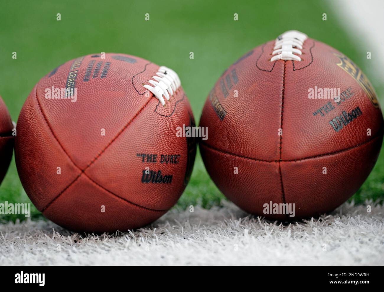 Footballs sit on the sidelines before the start of the NFL preseason ...