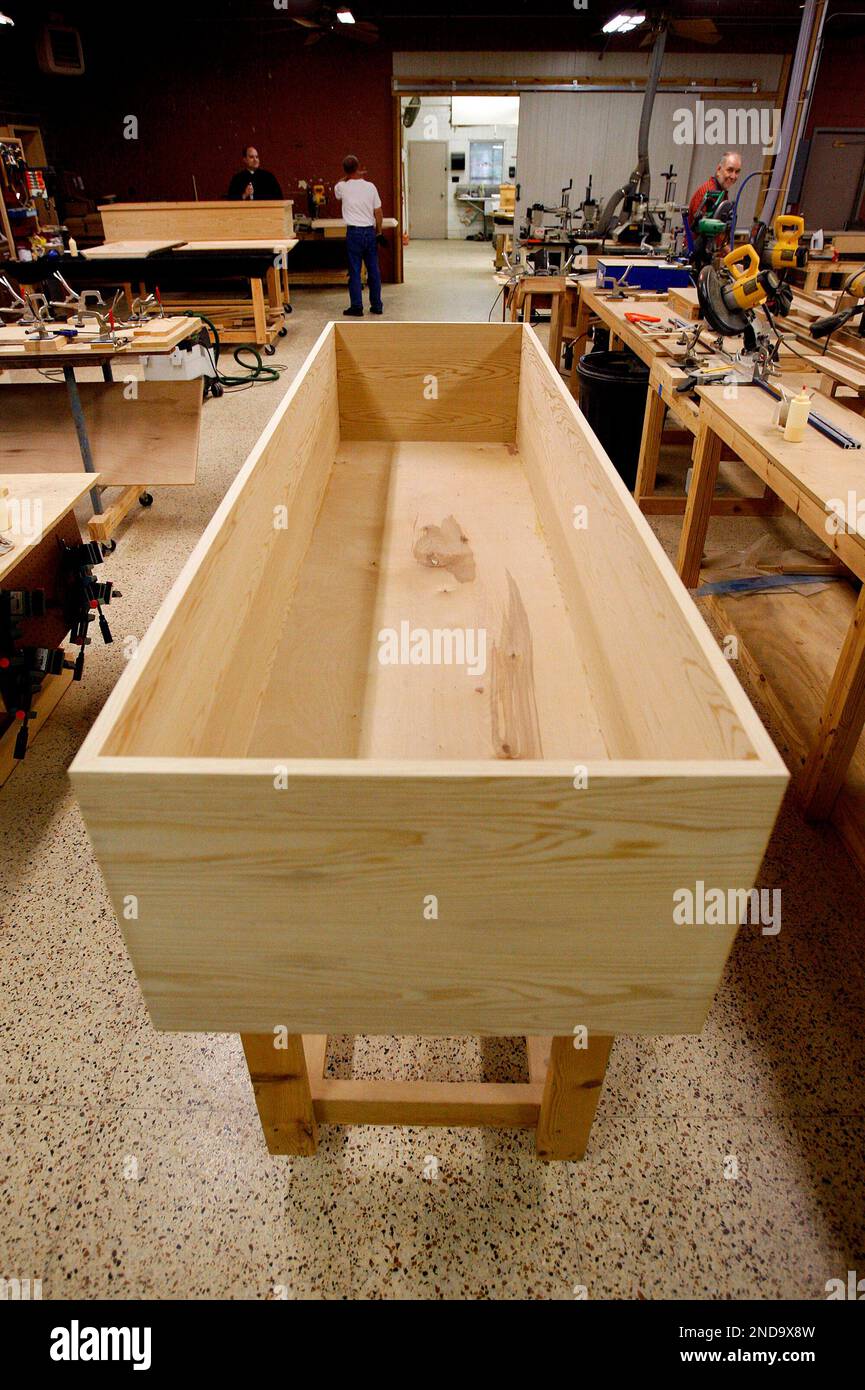 An unfinished casket lies inside a workshop at St. Joseph Abbey in ...