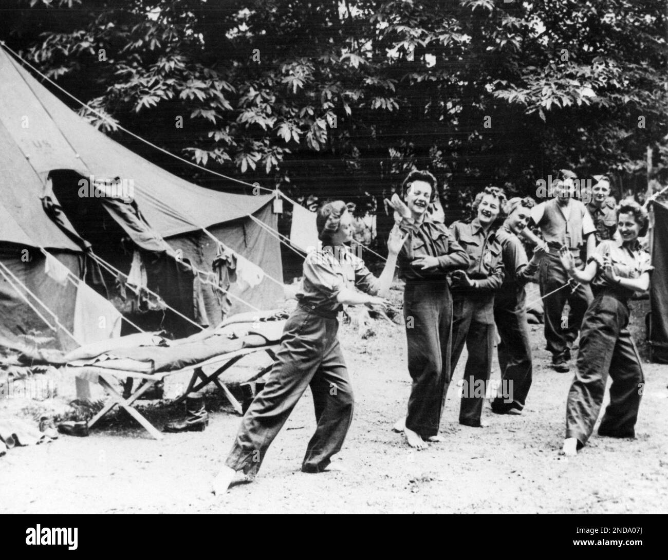 Two Canadian soldiers enjoy the preview as these Canadian WACs practice ...
