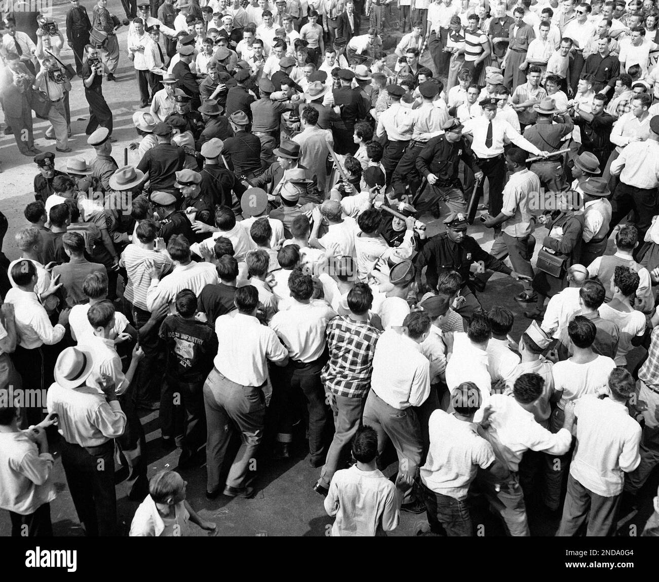 Police try to hold back crowds and make a lane through which followers ...