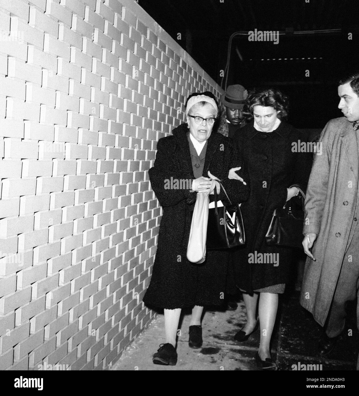 Mrs. Paul Robeson, wife of the famed baritone, is accompanied by her ...