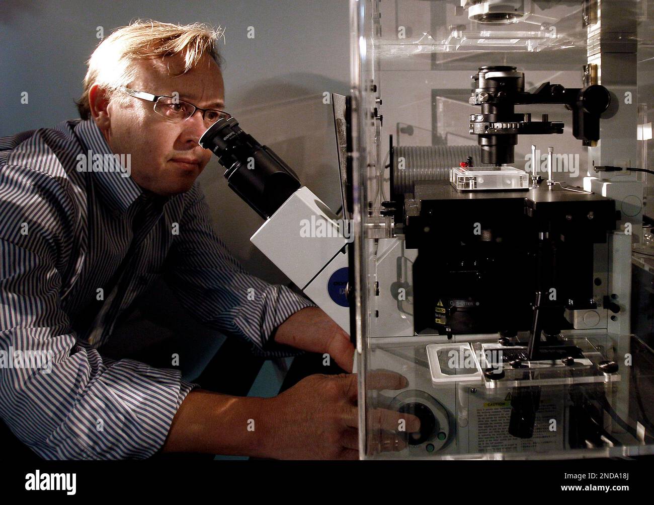 In this Wednesday Aug. 4, 2010 photo Dr. Becker uses a microscope at ...
