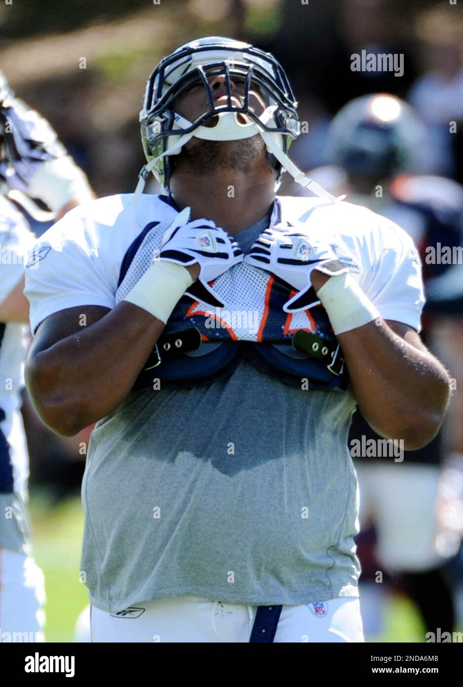Denver Broncos offensive lineman Stanley Daniels reacts to the heat ...
