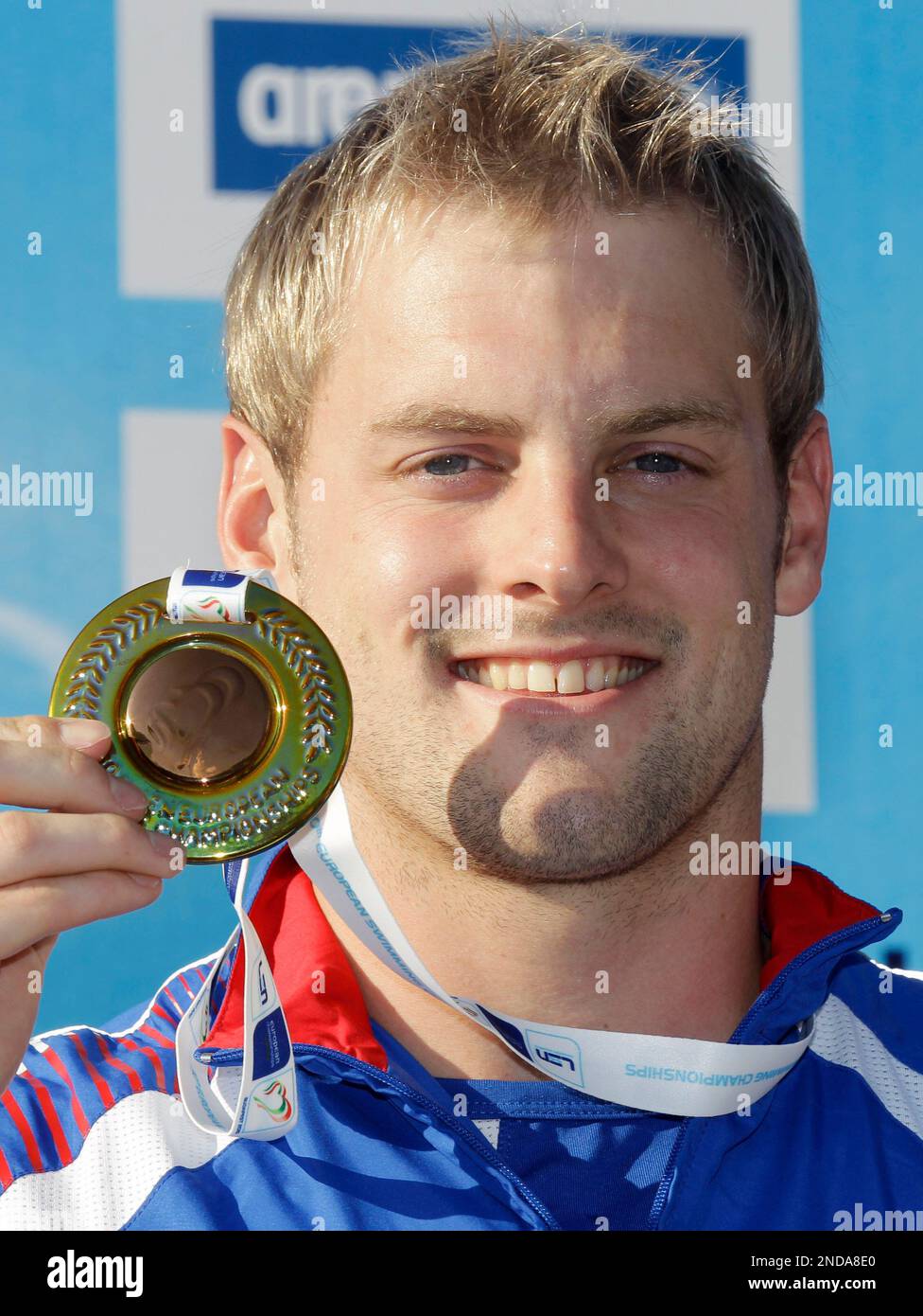 Britain's Liam Tancock shows off his bronze medal after the Men's 100m ...