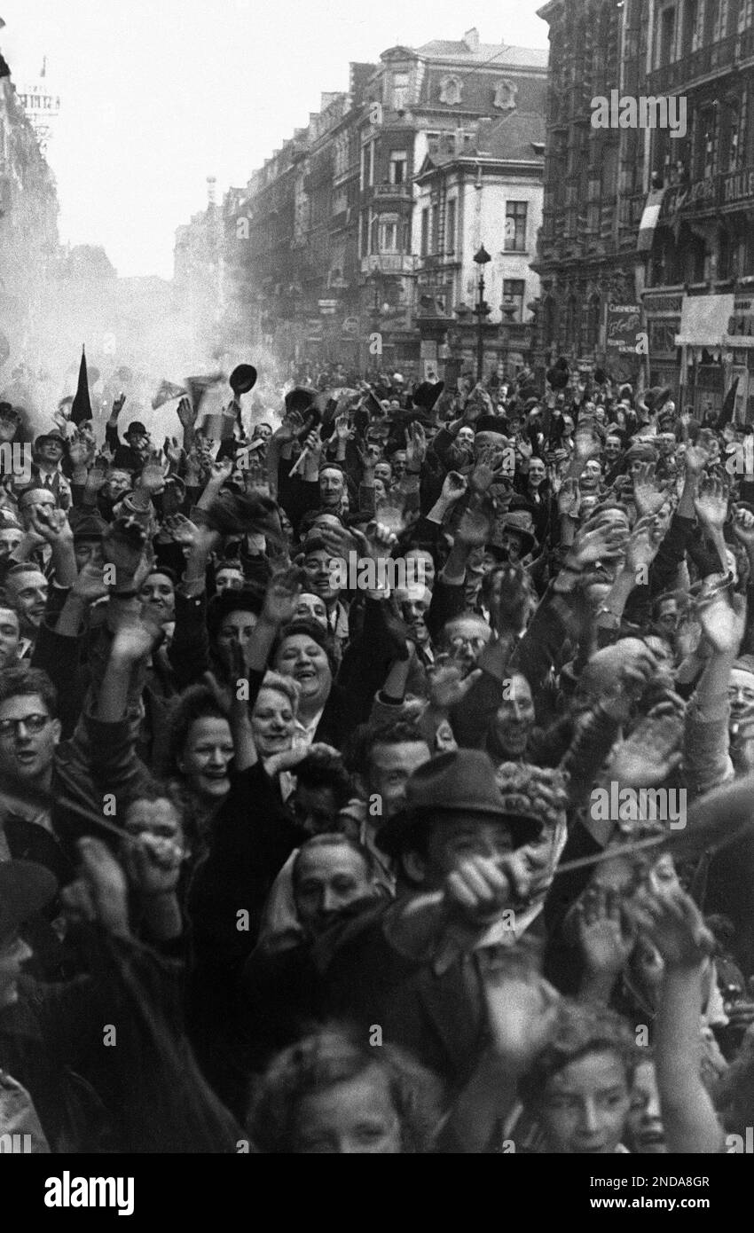 Cheering crowds in the streets of Brussels, Belgium, on Feb. 21, 1945 ...