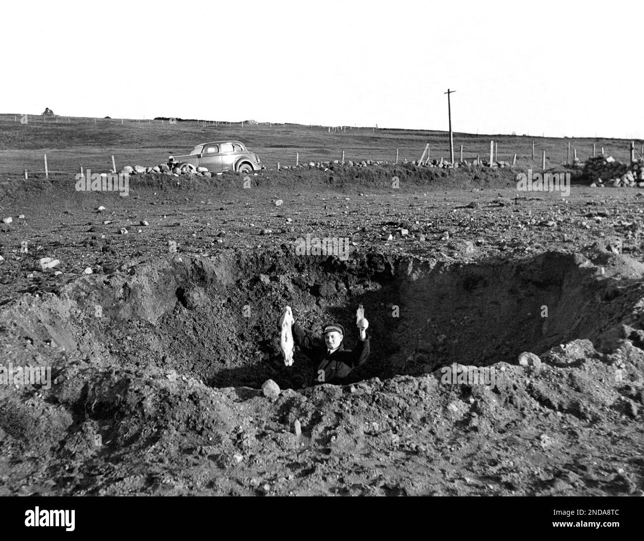 Standing in the deepest crater made by German bombs dropped in the ...