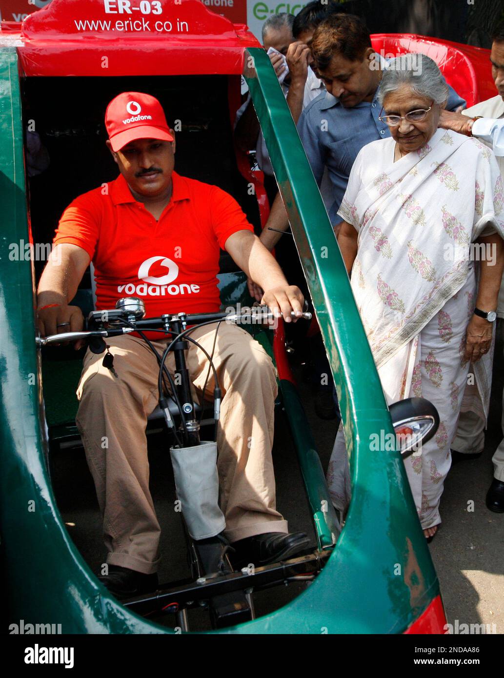New Delhi Chief Minister Sheila Dikshit, right, checks a battery ...
