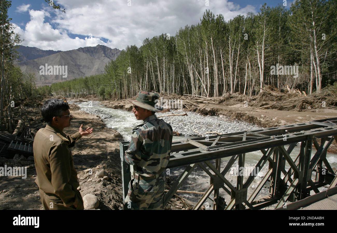 Indian army officers look on at a the site of destruction wrecked by a ...