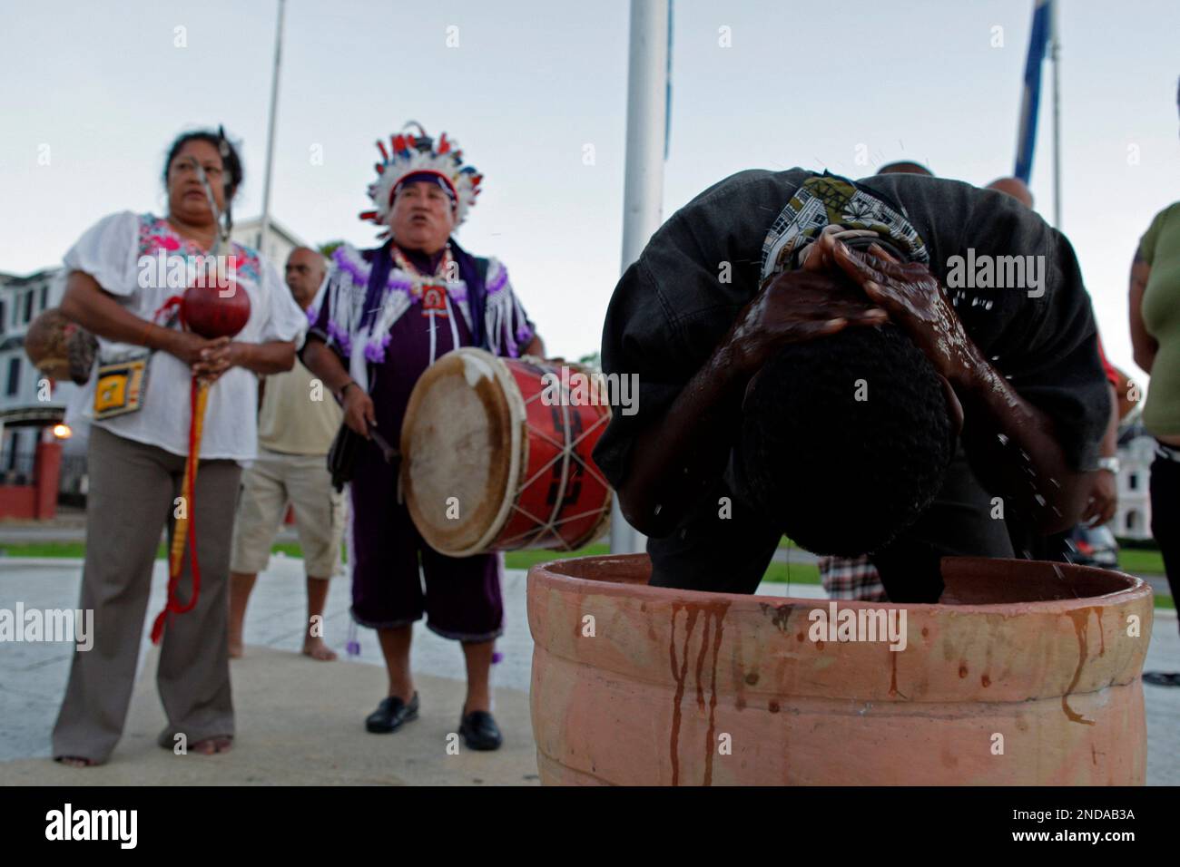 A Surinamese man washes with ceremonial water as Amerindian indigenous ...