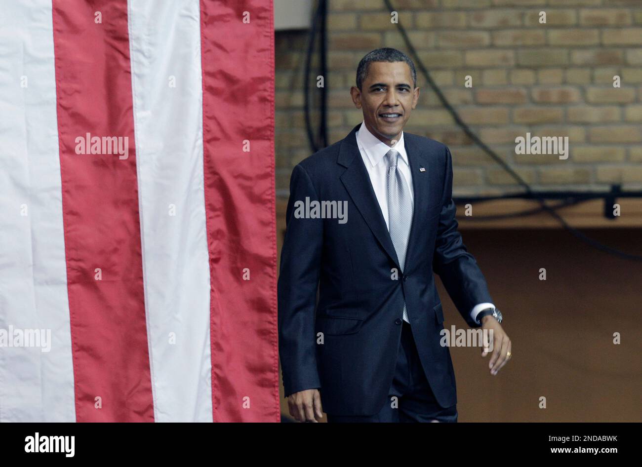 President Barack Obama walks on stage to give a speech at Gregory Gym ...