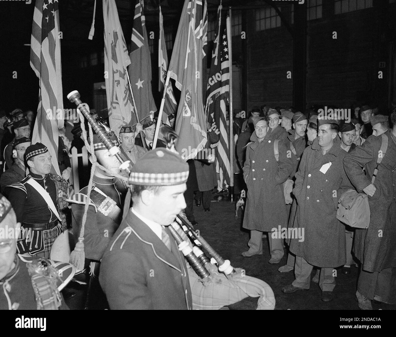 The Caledonian bagpipe band of the Canadian legion, left, pipes a ...