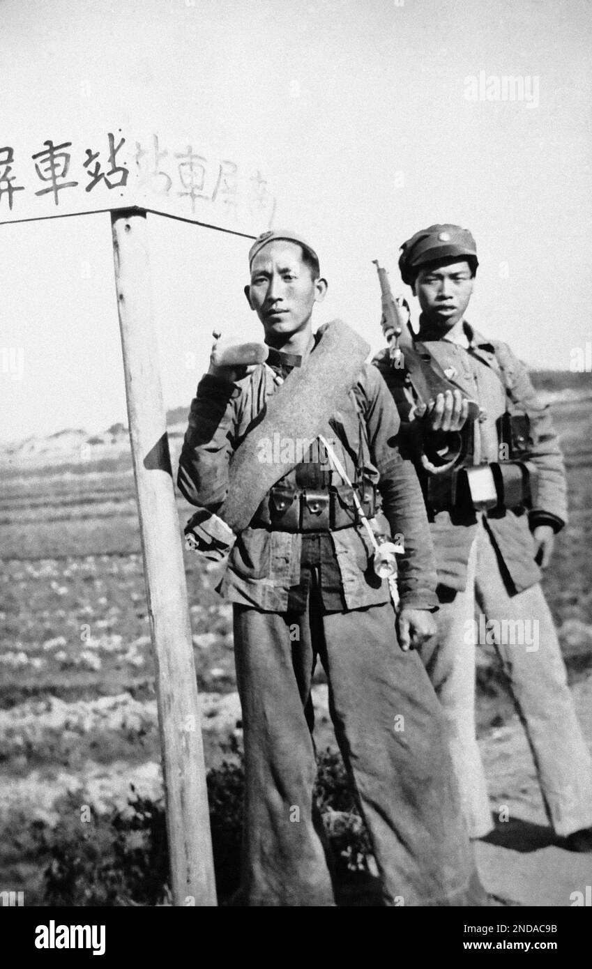 Two Chinese guerrillas standing guard somewhere in the Pearl River ...