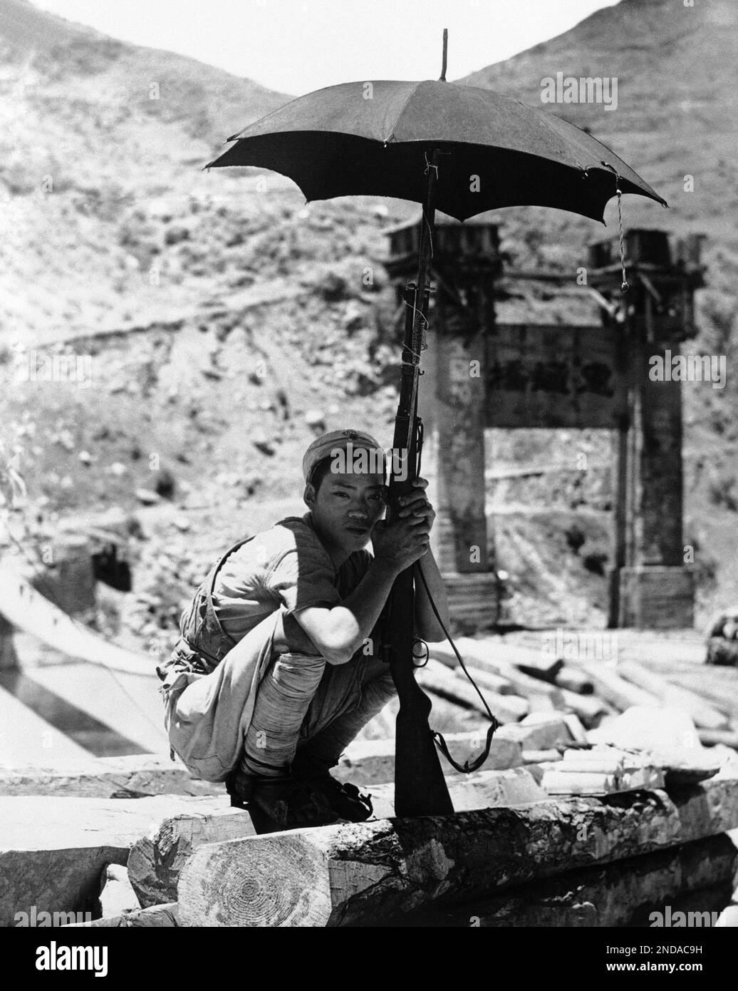 While required to keep his rifle in hand to protect the Hwitung Bridge ...