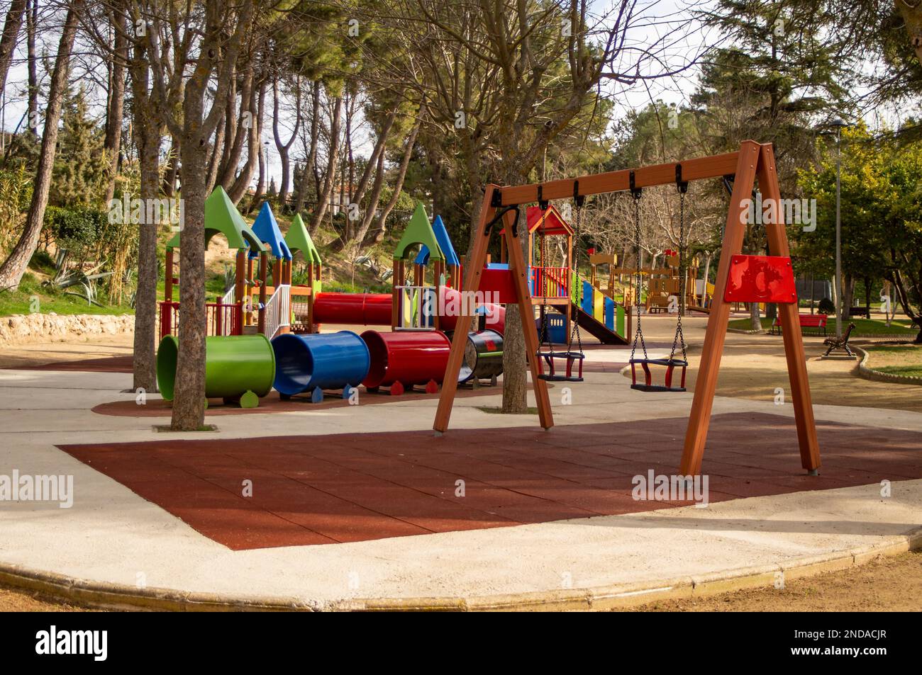 Children's play area with swing, slide, climbing ladder, sandbox ...