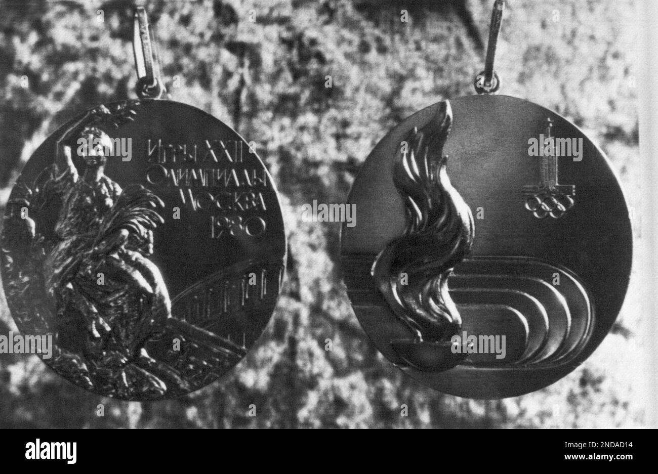 This photograph shows the front and rear of the Olympic gold medal as ...