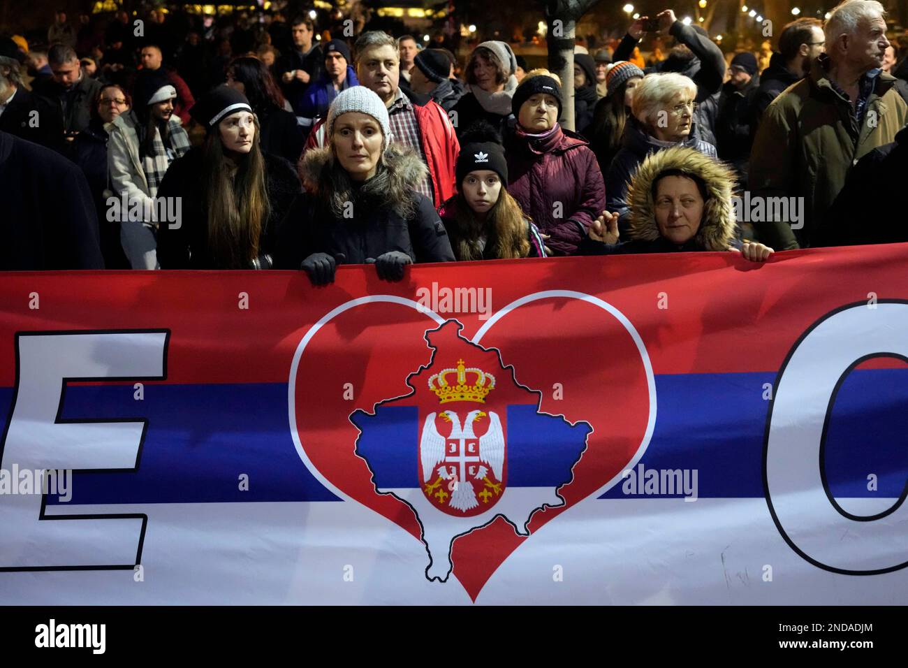 People hold a Serbian flag with the map of Kosovo during a protest ...