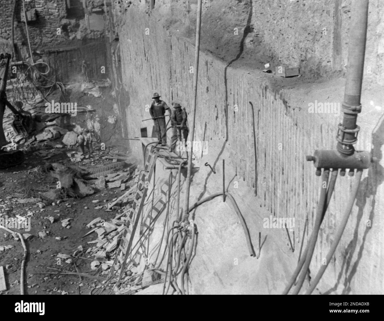 Workmen must penetrate solid rock to a depth of seventy feet in making ...