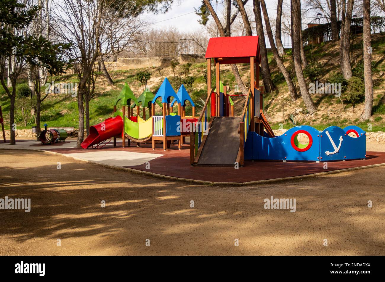 Children's play area with swing, slide, climbing ladder, sandbox ...