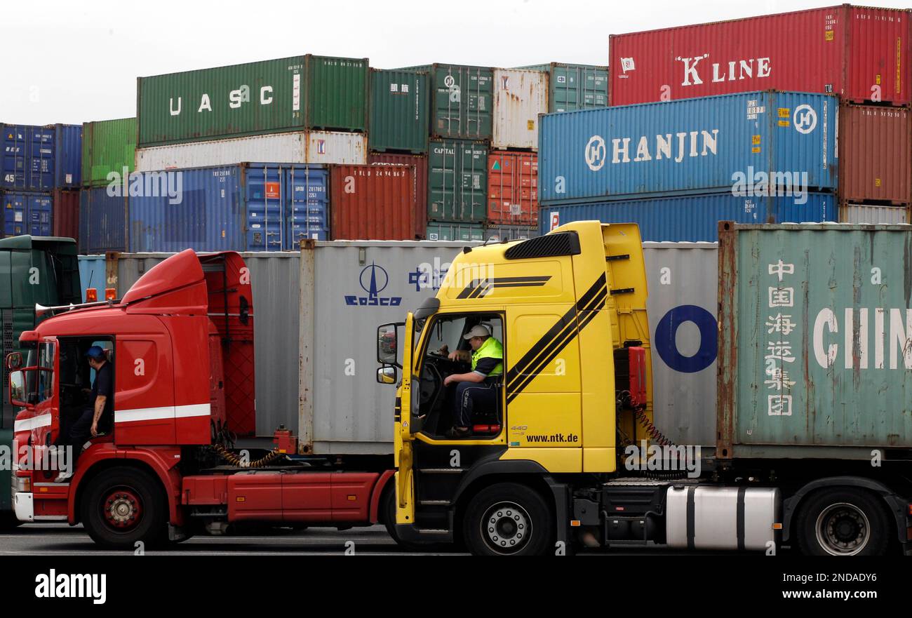 Trucks line up to wait in front of piling container at the Container ...