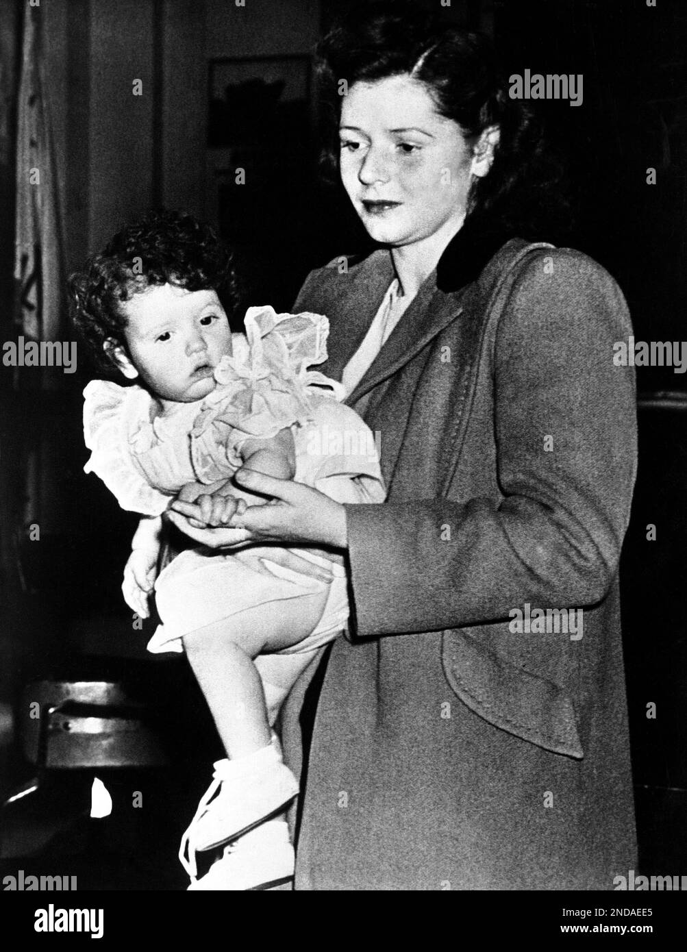 Joan Barry holds her baby, Carol Ann before the jury box during trial ...