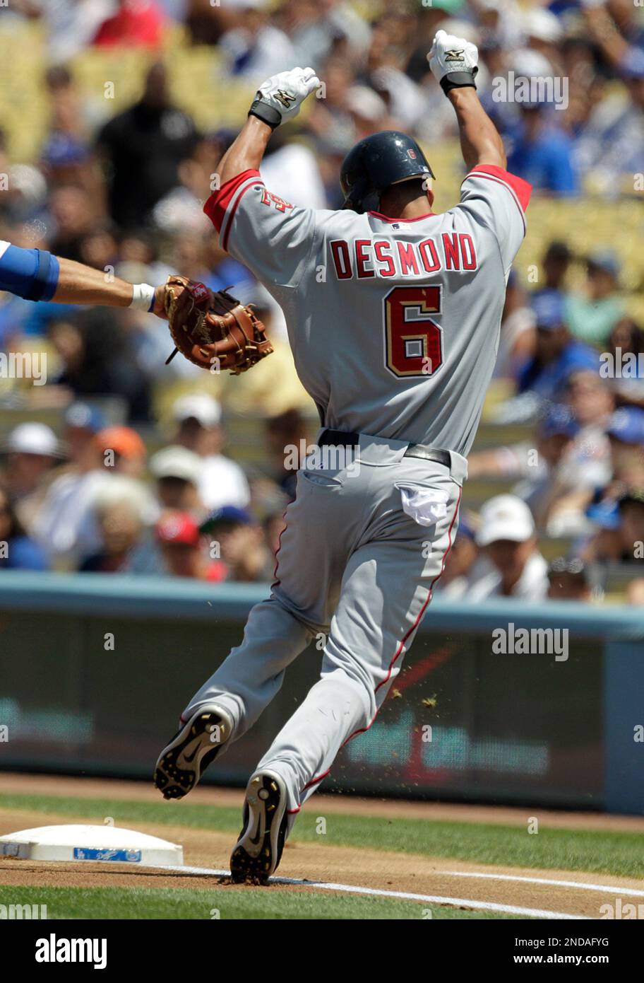 Washington Nationals' Ian Desmond takes first base as he avoids a tag ...