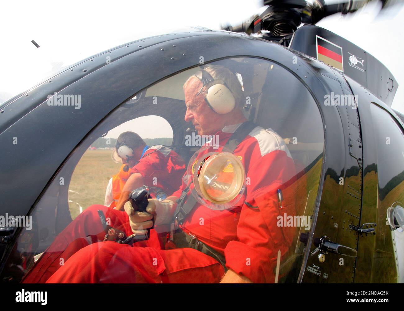 German pilot Gunter Zimmer, 74, sits in the cockpit of his Hughes 500 ...