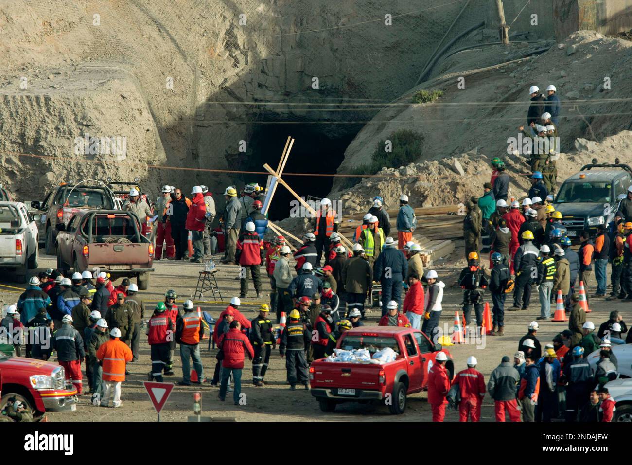 Miners, relatives and rescue workers stand outside a collapsed copper ...