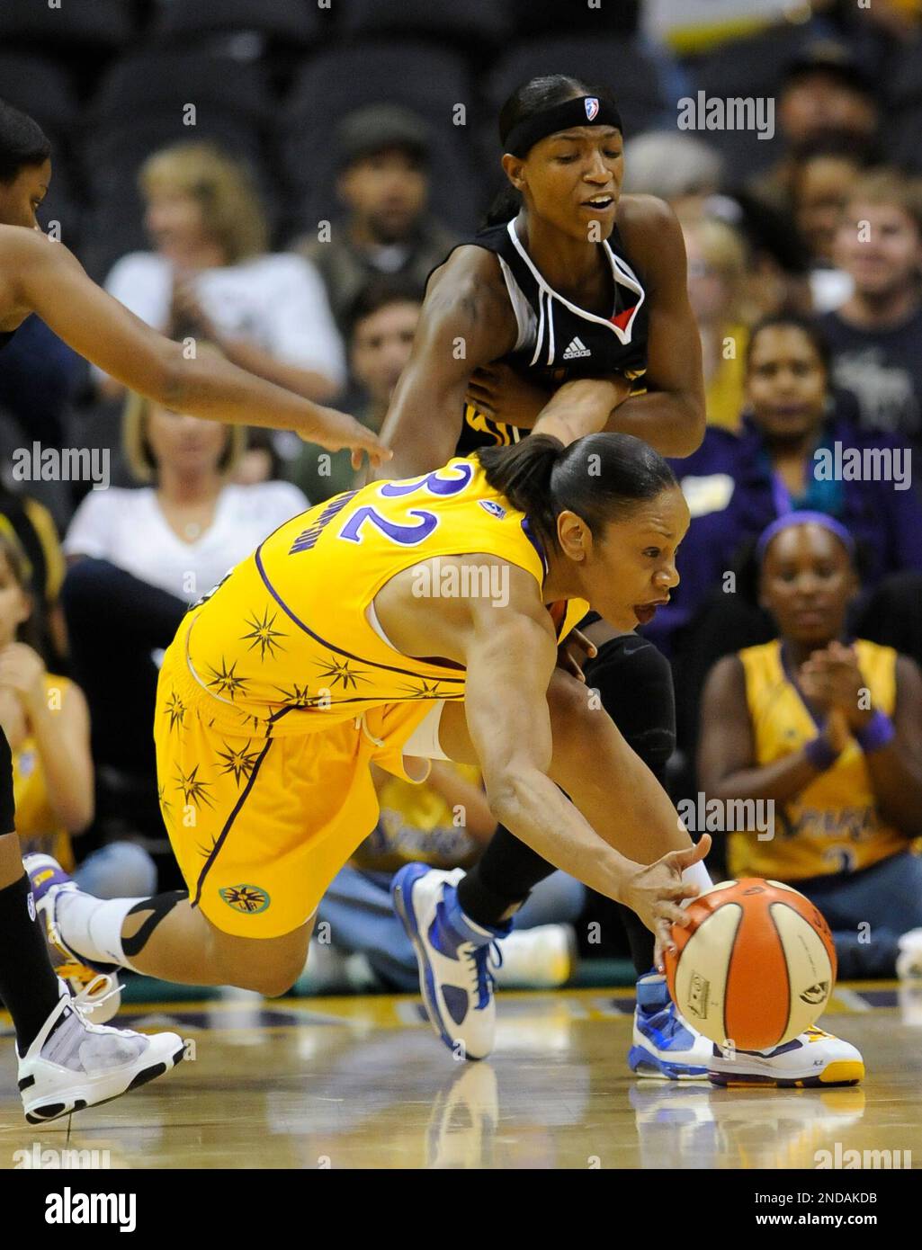 Los Angeles Sparks forward Tina Thompson (32) and Tulsa Shock forward Rashanda McCants, back ...