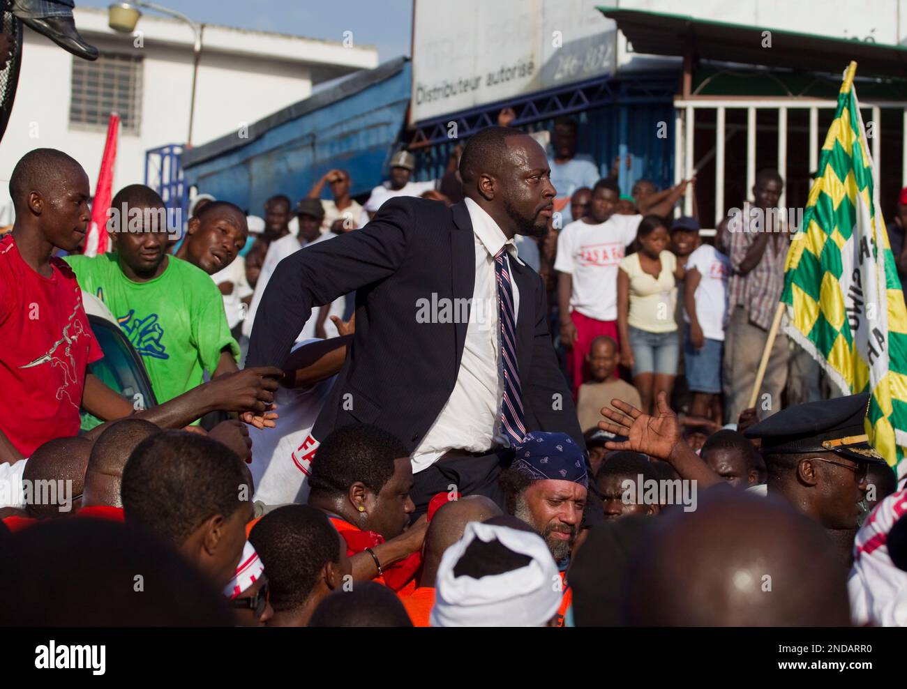 Haitian-born singer Wyclef Jean, center, is greeted by supporters after ...