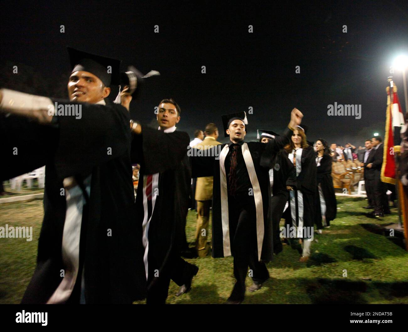 University graduates dance as they celebrate during a graduation ...