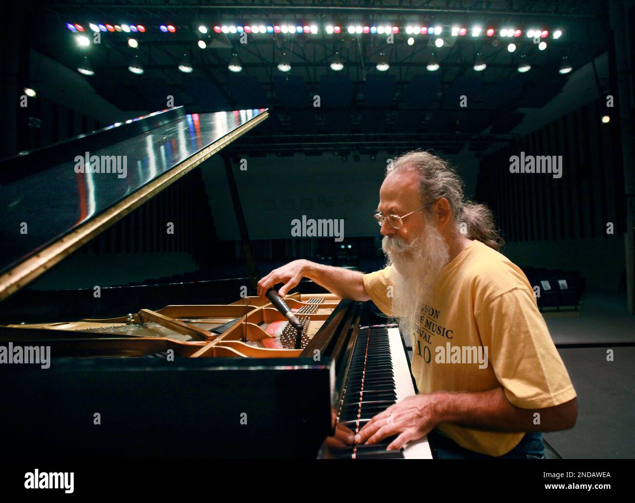 In this July 26, 2010 photo, piano tuner Bill Calhoun, who is marking ...