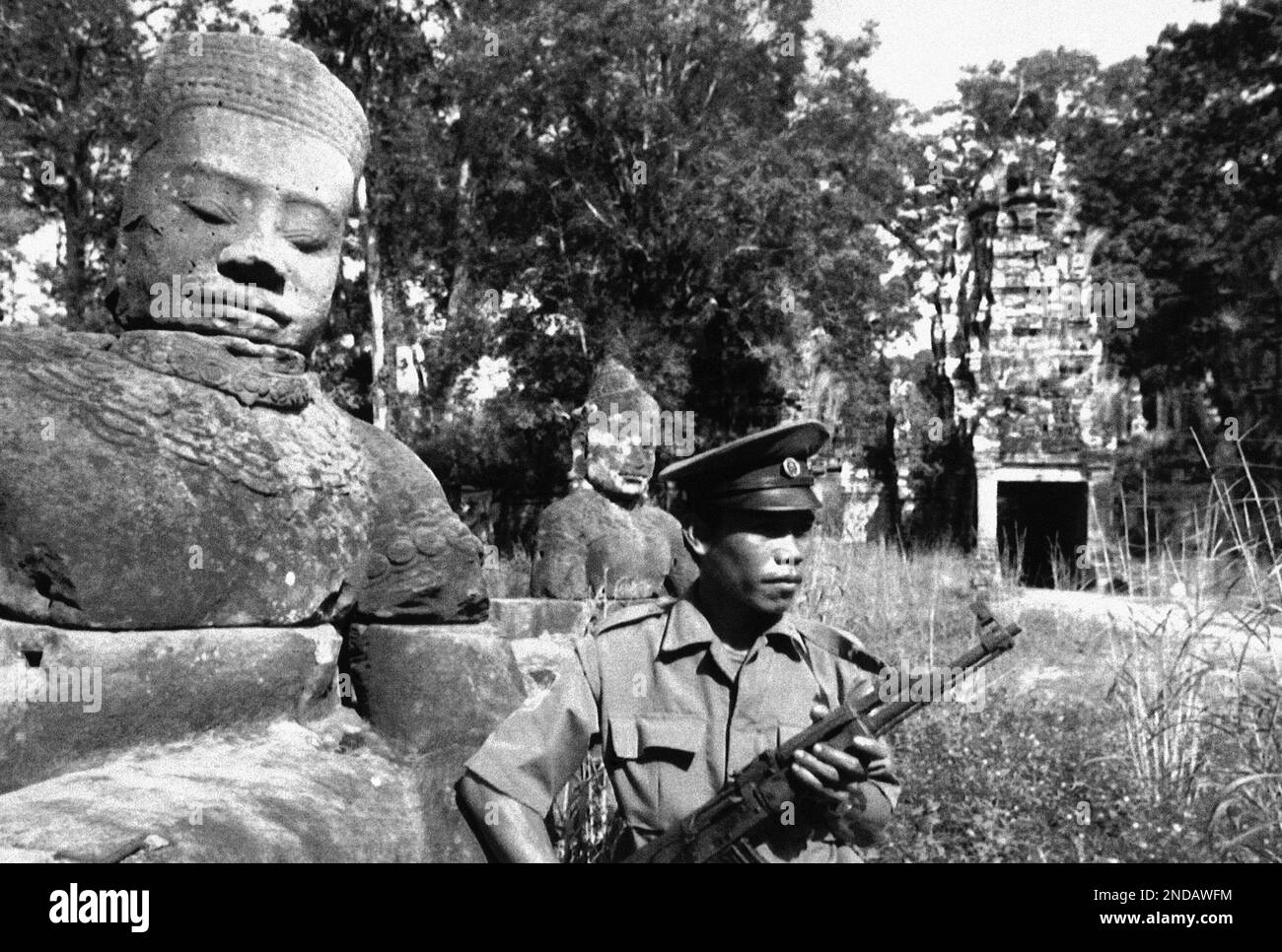 A Cambodian government soldier armed with an AK-47, stands guard in ...