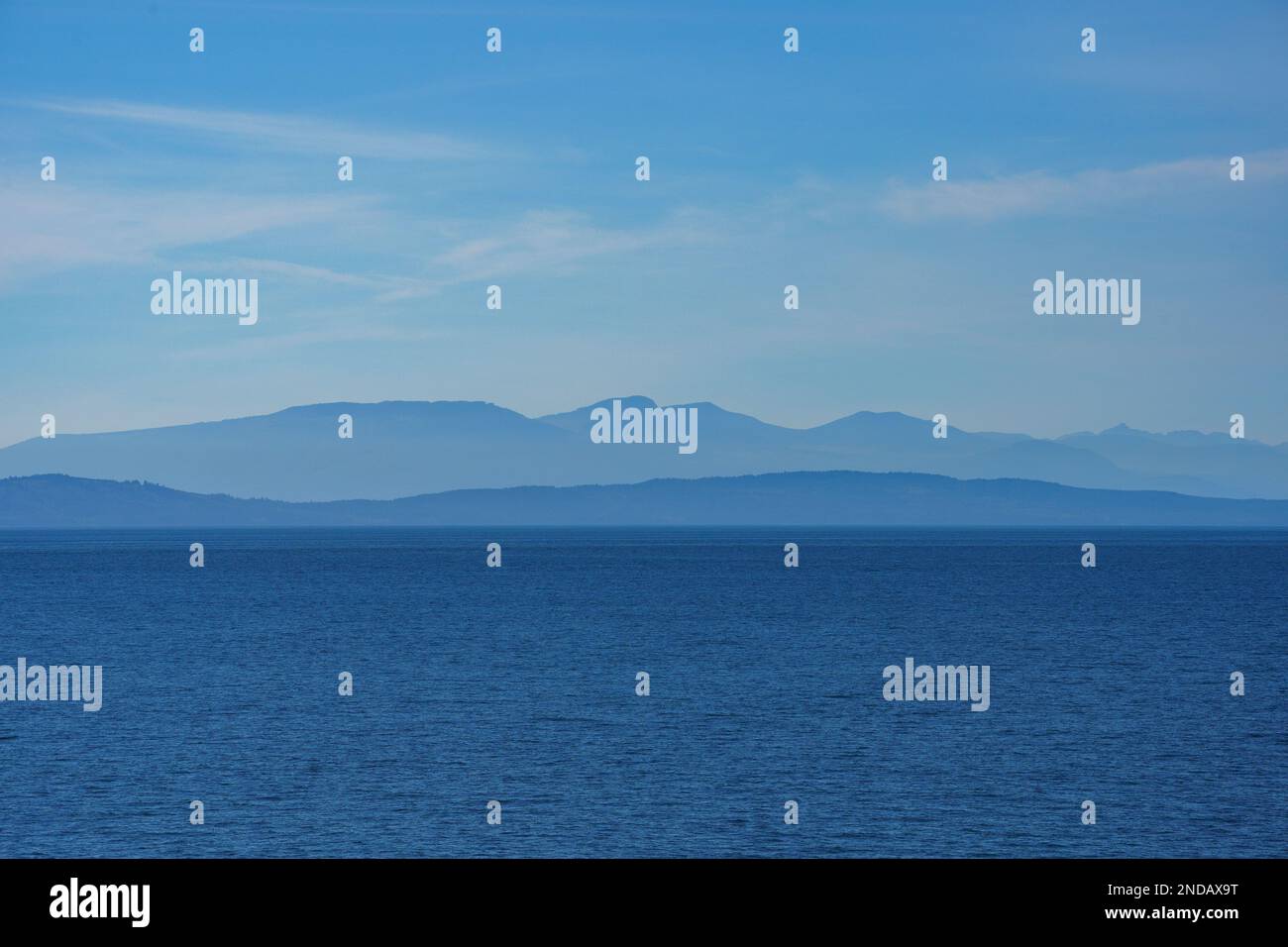 The Shades of Blue of the ocean, land and sky Stock Photo - Alamy
