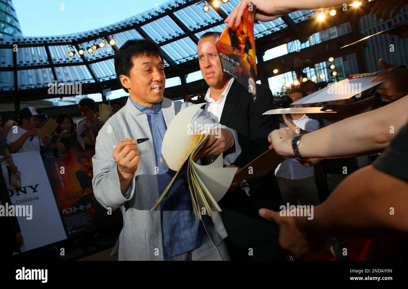 Hong Kong actor Jackie Chan signs autographs for Japanese fans before ...