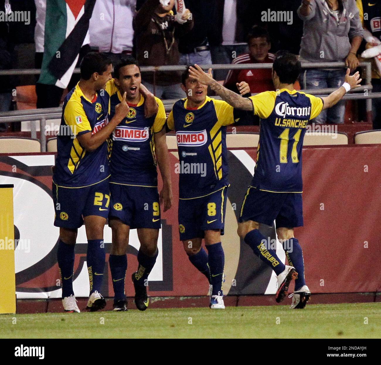 Club America's Enrique Esqueda, second from left, is hugged by second ...