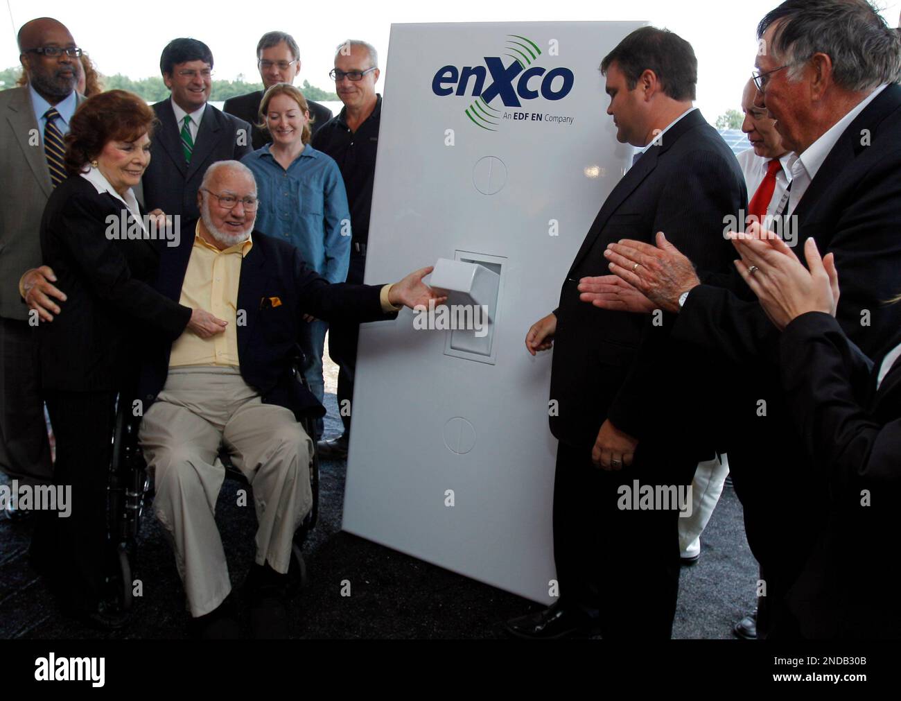 Joseph Mattioli, left, flips the ceremonial switch for a field of solar ...