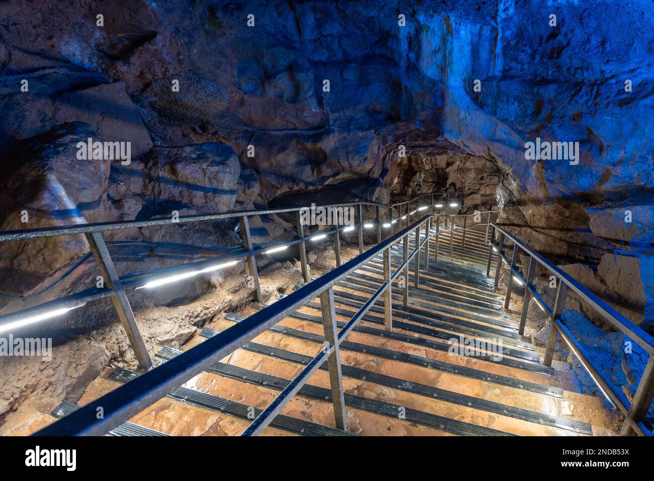 An illuminated staircase inside Goughs Cave in Cheddar in Somerset ...
