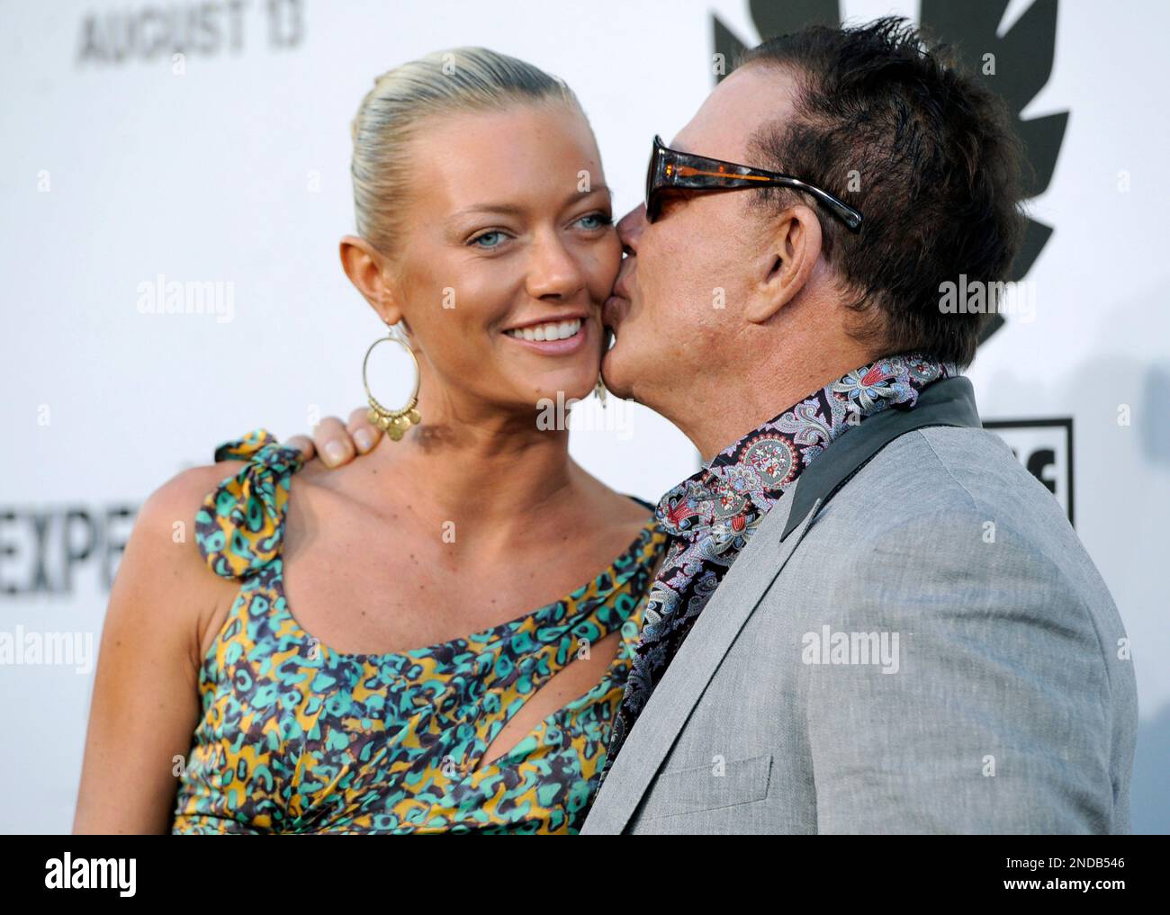 Mickey Rourke, a cast member in "The Expendables," kisses his ...
