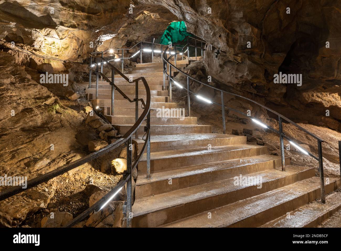 An illuminated staircase inside Goughs Cave in Cheddar in Somerset ...