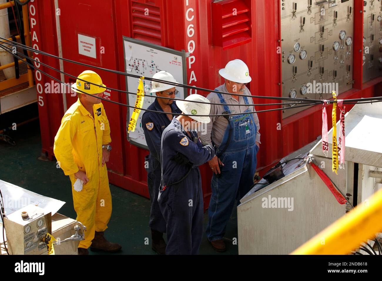 Workers on the Helix Q4000, which is performing the static kill ...