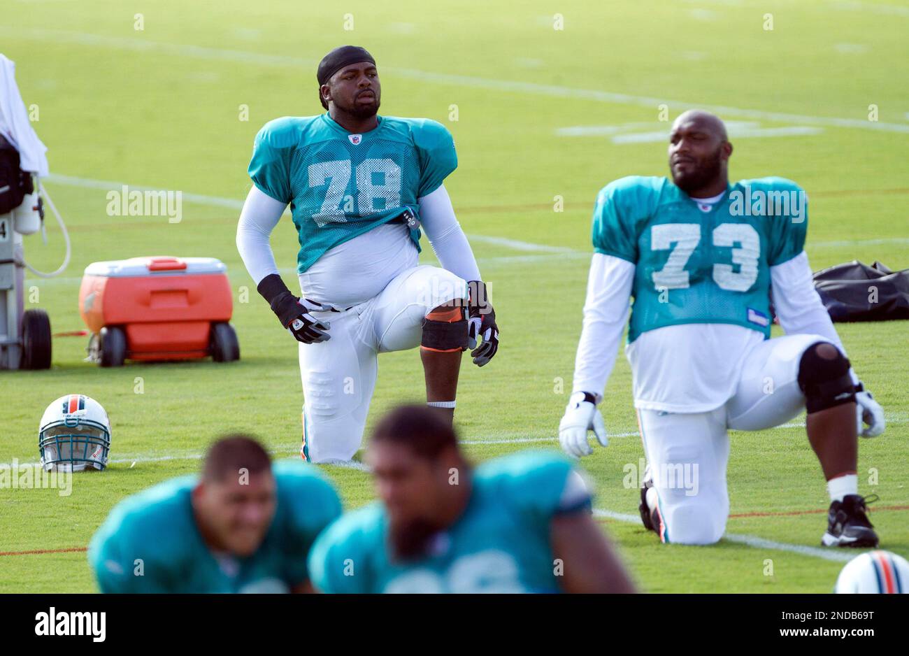 Miami Dolphins player Montavious Stanley (73) and Tony McDaniel (78) stretch during morning ...