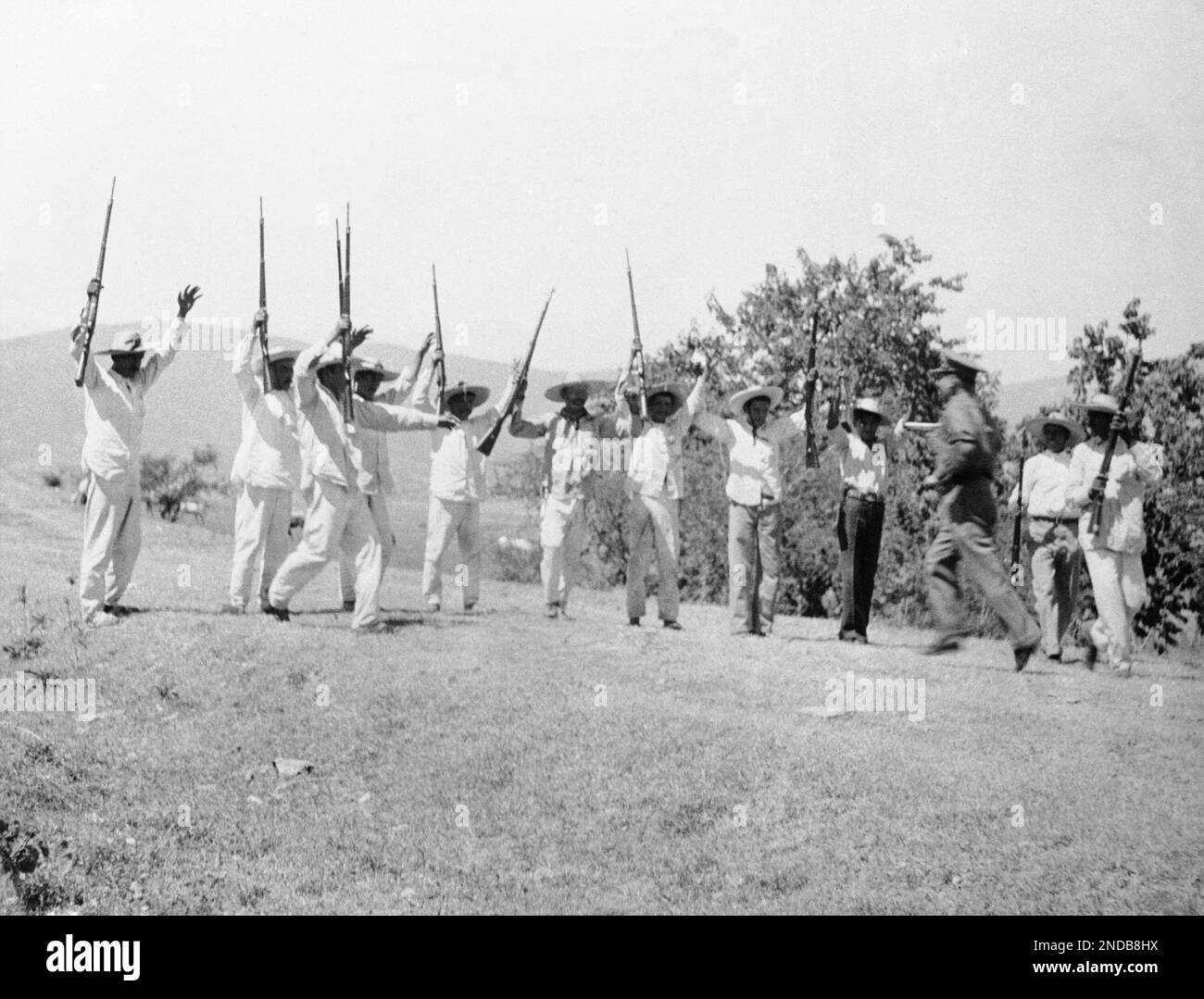 A group of rebels, part of the 70 who yielded, surrender near Iguala ...