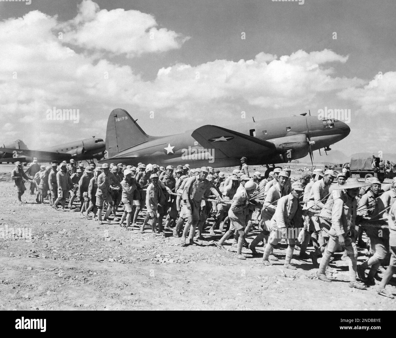 Chinese laborers and soldiers of an airfield garrison force, harnessed ...