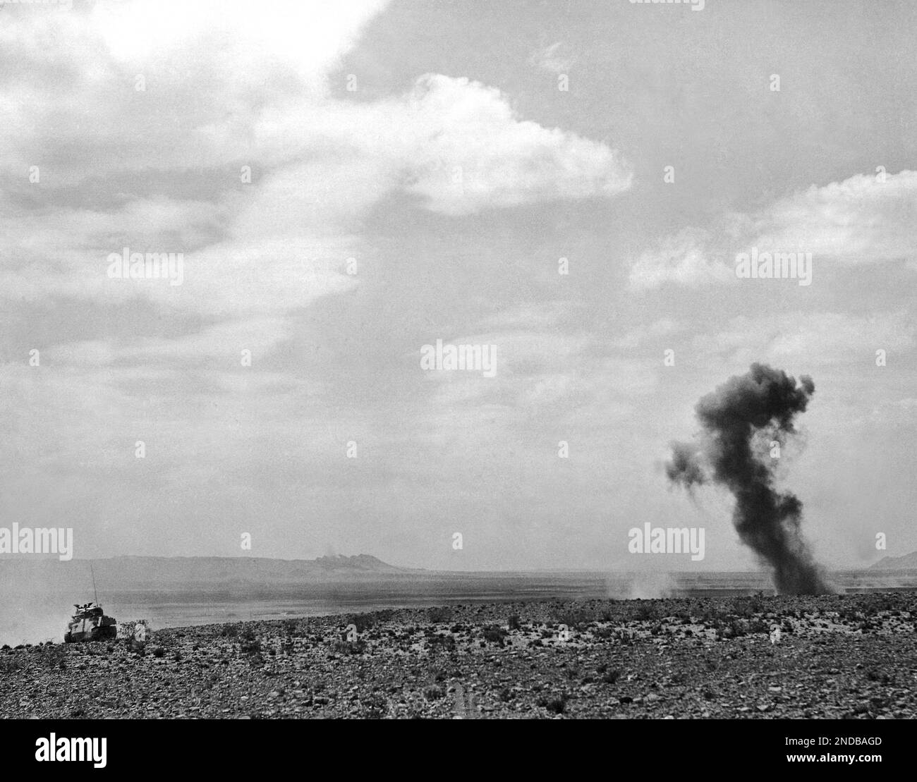 Dark smoke blows away across a Central Tunisian plain April 24 as ...