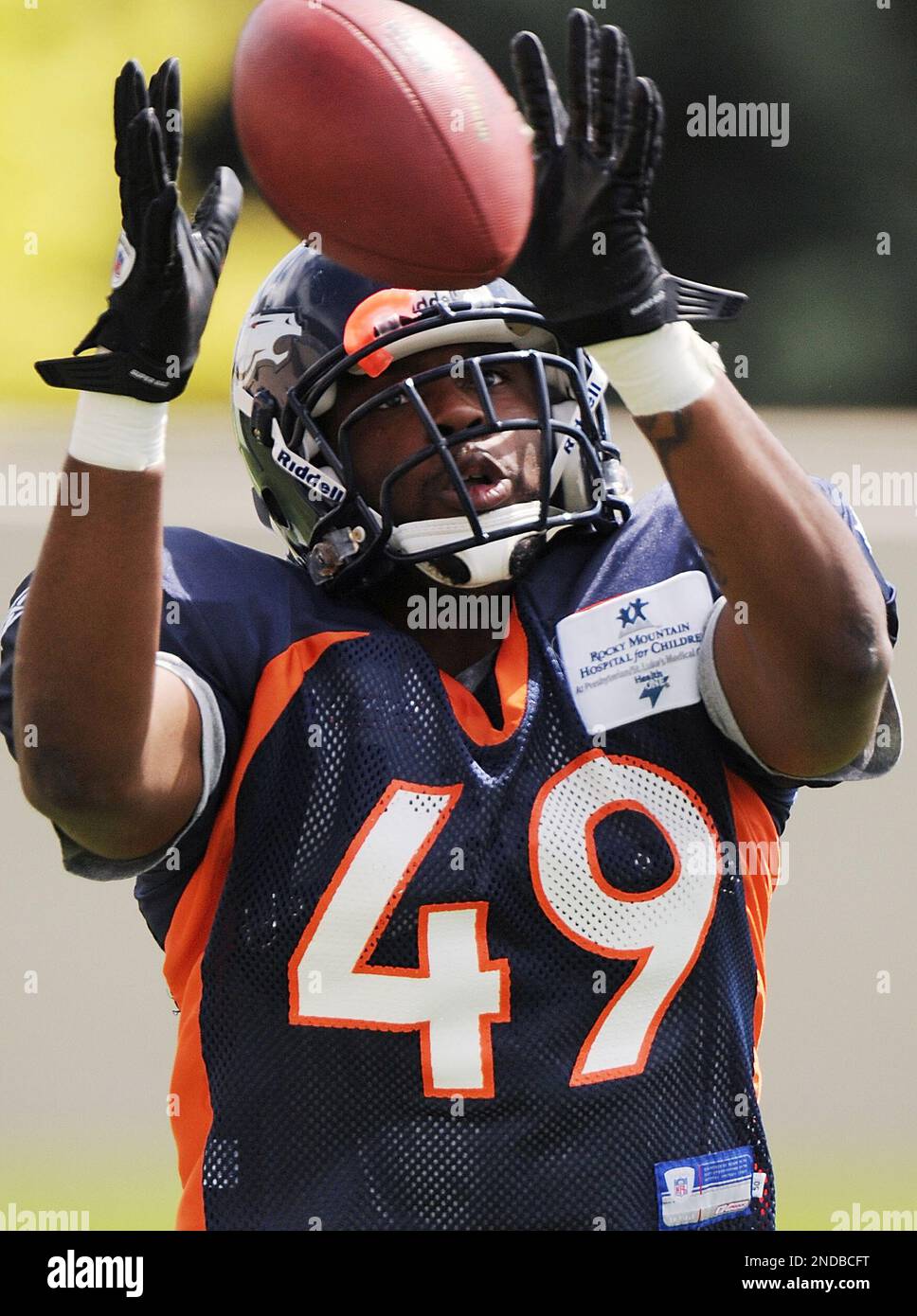 Denver Broncos rookie linebacker Devon Bishop looks to grab a pass ...
