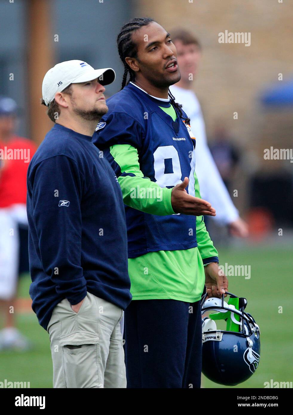Seattle Seahawks general manager John Schneider, left, stands with T.J ...