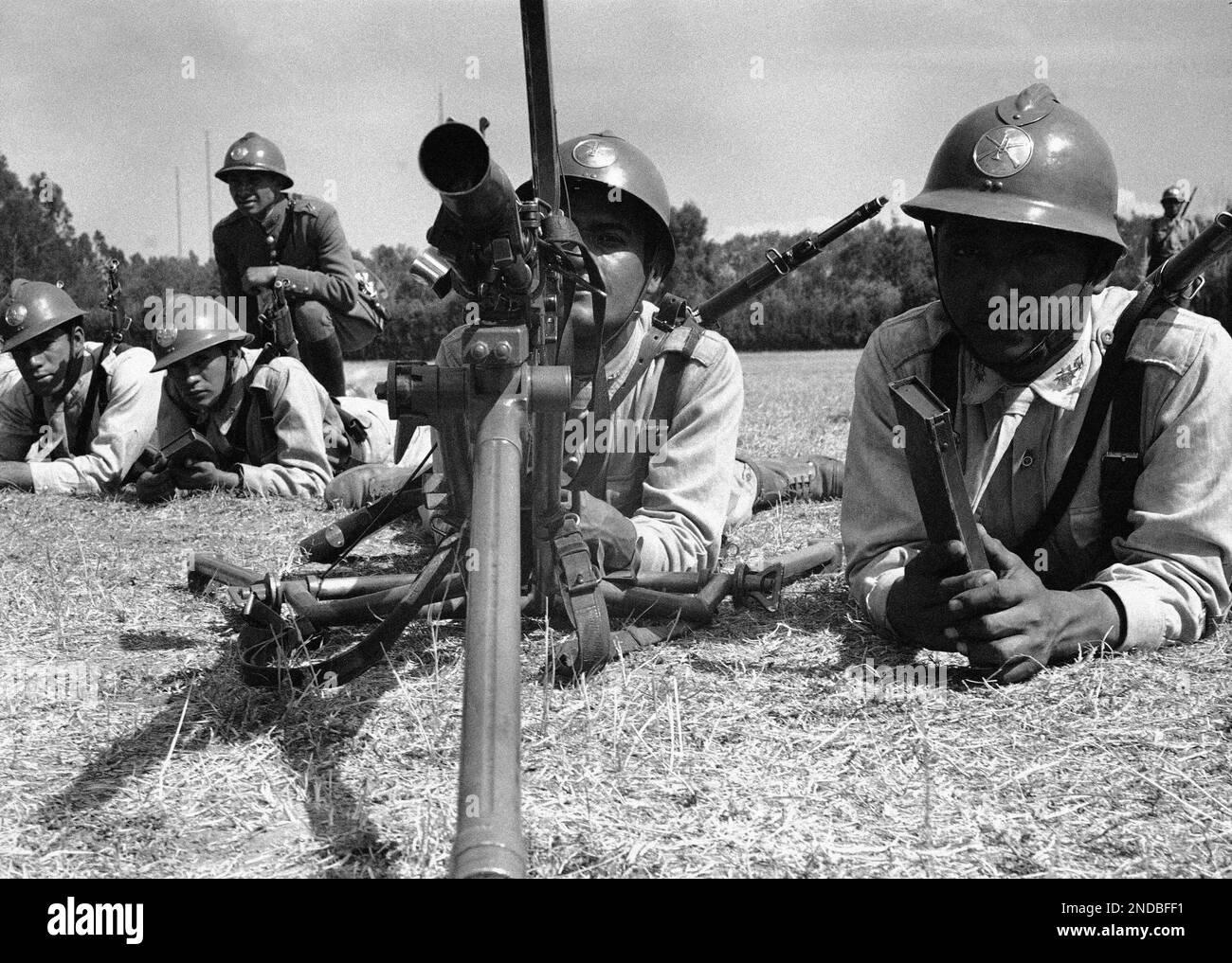A Mexican machine gun crew, gun aimed and ready to fire, awaits its ...