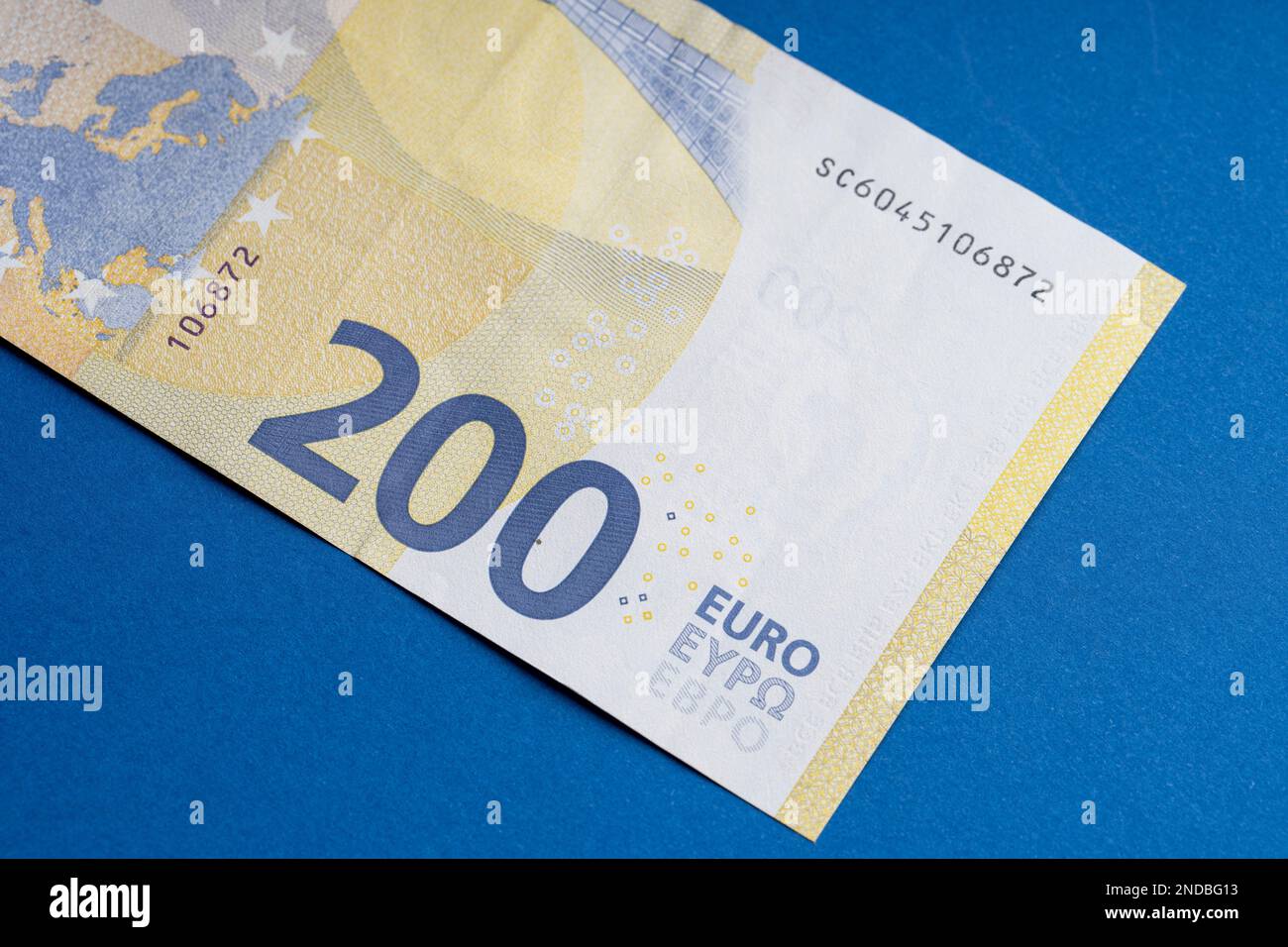 200 euro banknote close up, blue background for business finance topics ...